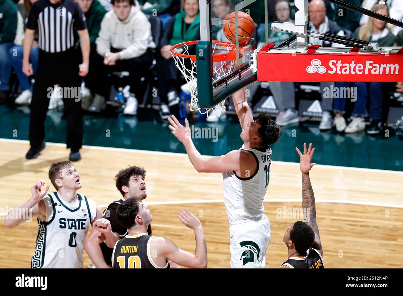 Michigan State center Szymon Zapala, top, shoots a reverse layup ...