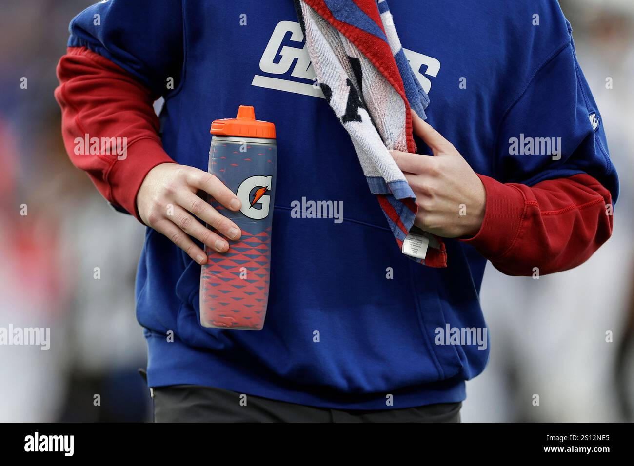 A New York Giants trainer holds a Gatorade bottle during an NFL ...