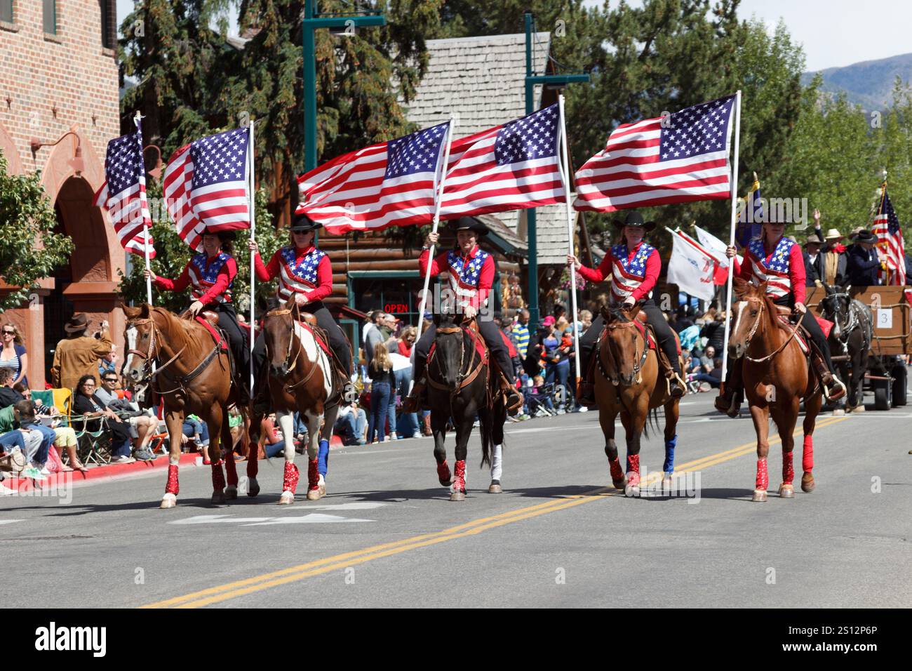 Patriotic Horseback Riders Holding American Flags in a Public Municipal ...