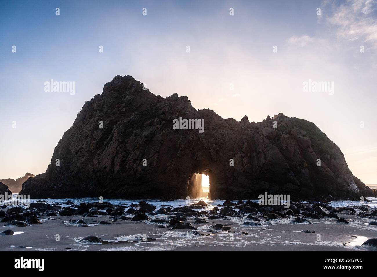 Wide-angle shot of the keyhole arch at Pfeiffer beach, California, whit ...