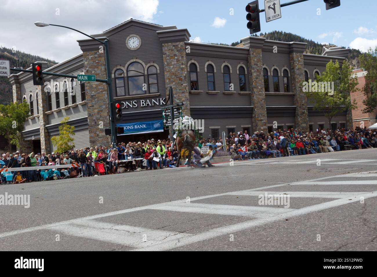 Crowded Parade Scene with Horse and Onlookers Displaying Community ...