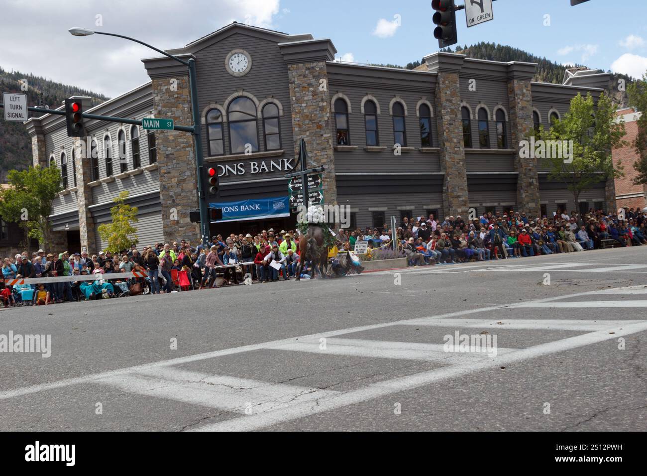 Crowded Parade Scene with Horse and Onlookers Displaying Community ...