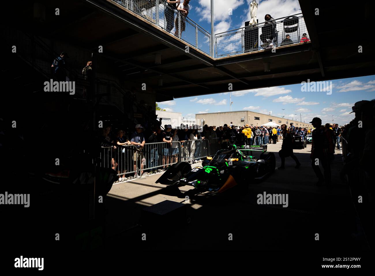 The crew of Juncos-Hollinger Racing tug the car of AGUSTIN HUGO ...