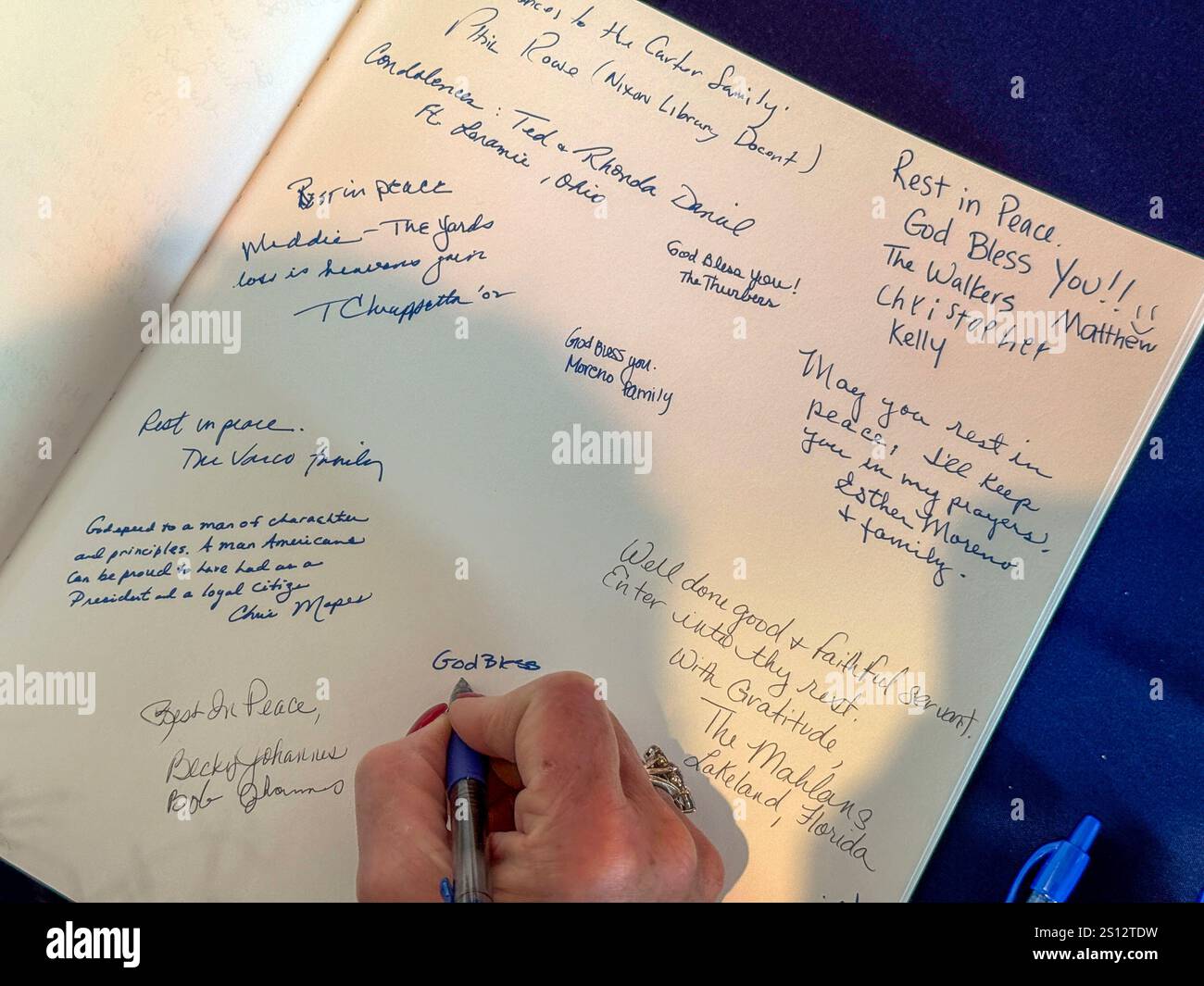 Visitors sign a condolence book for former President Jimmy Carter who ...