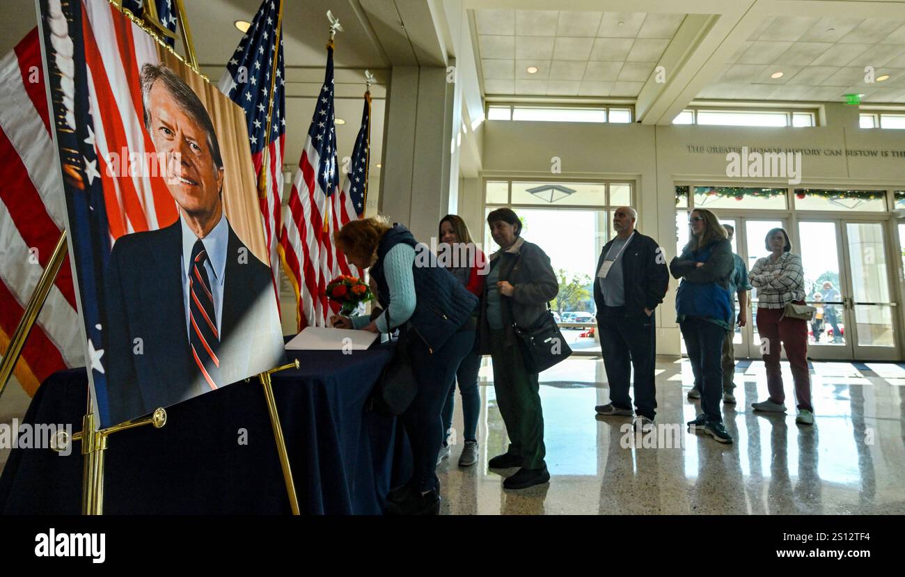 Visitors sign a condolence book for former President Jimmy Carter who ...