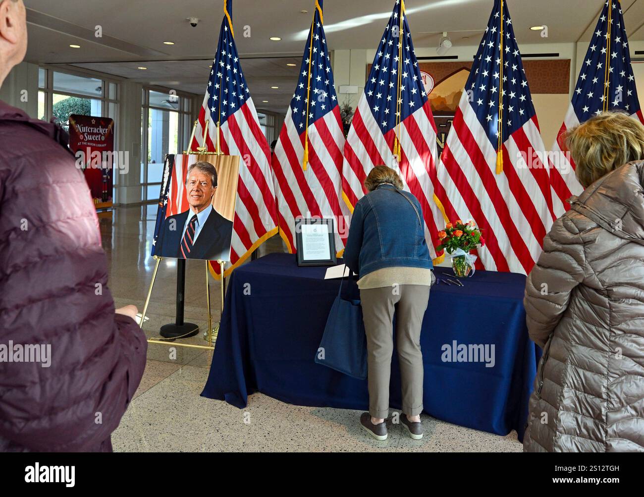 Chris Mapes, from Iowa, signs a condolence book for former President ...
