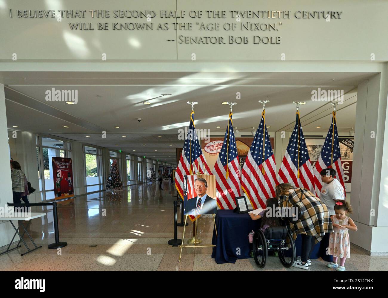 Visitors sign a condolence book for former President Jimmy Carter who ...