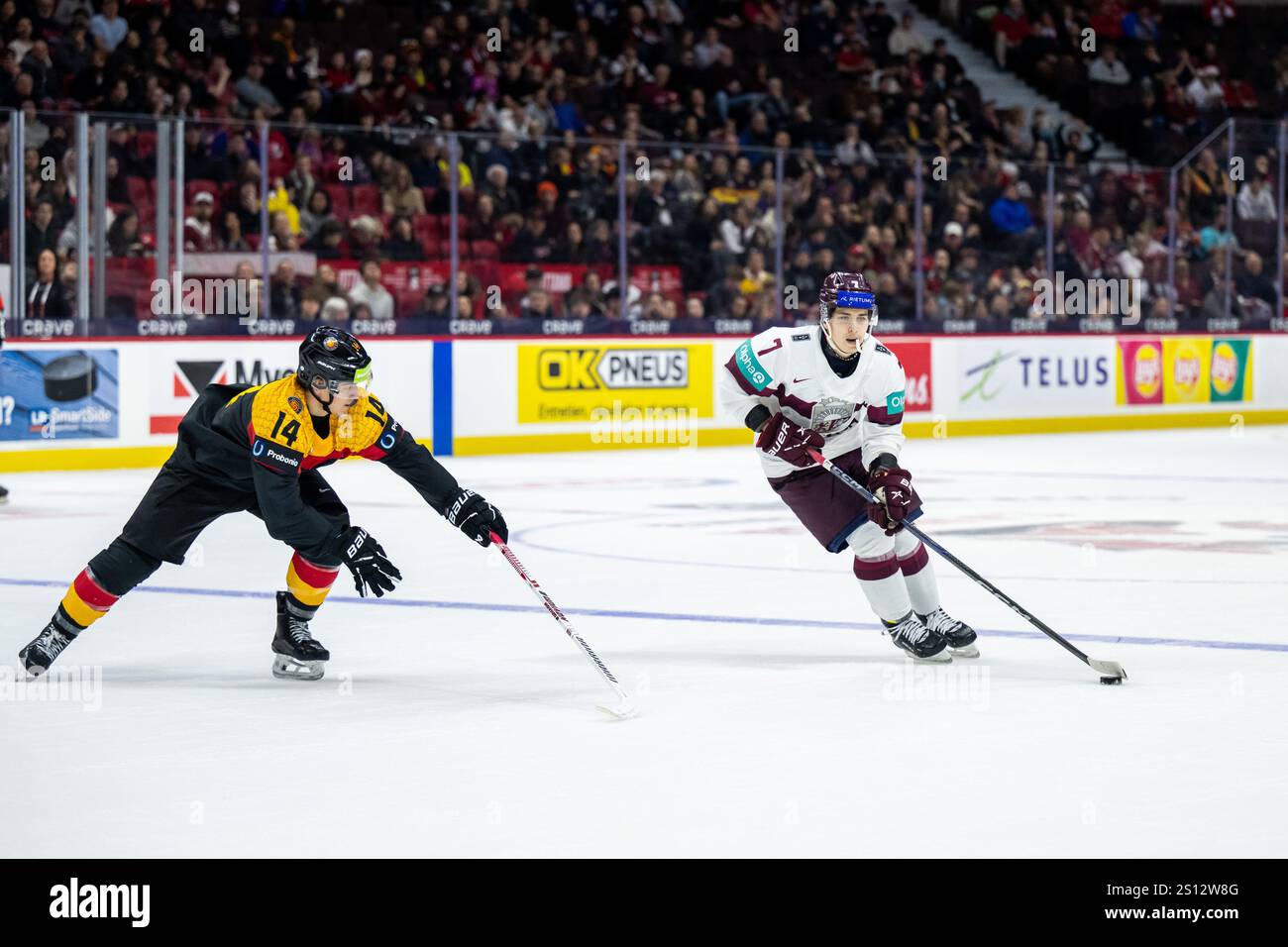 Nick Maul of, Germany. , . and Davids Livsics of Latvia during the 2025 IIHF World Junior ...