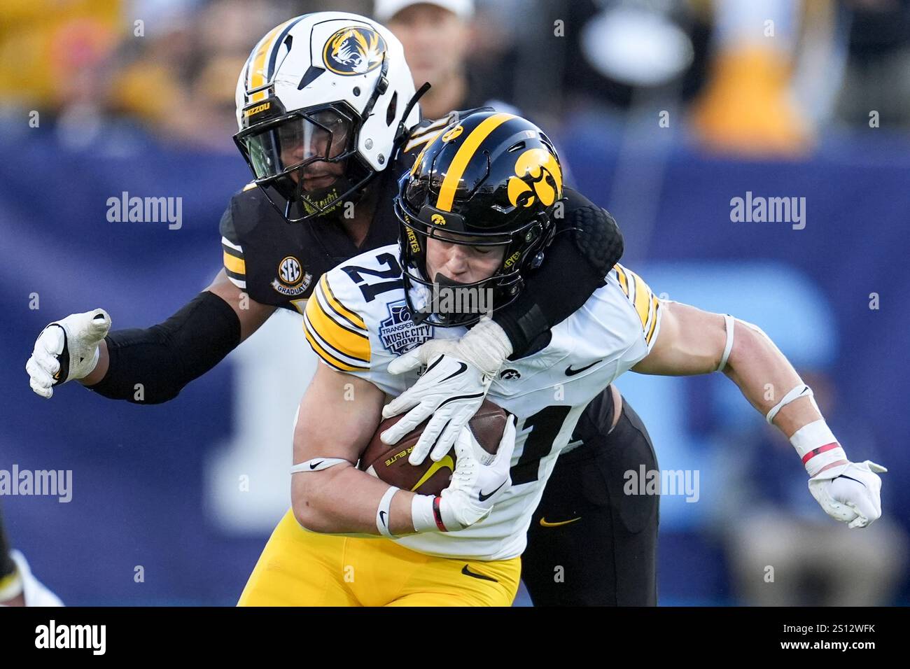 Missouri linebacker Corey Flagg Jr., left, tackles Iowa wide receiver ...
