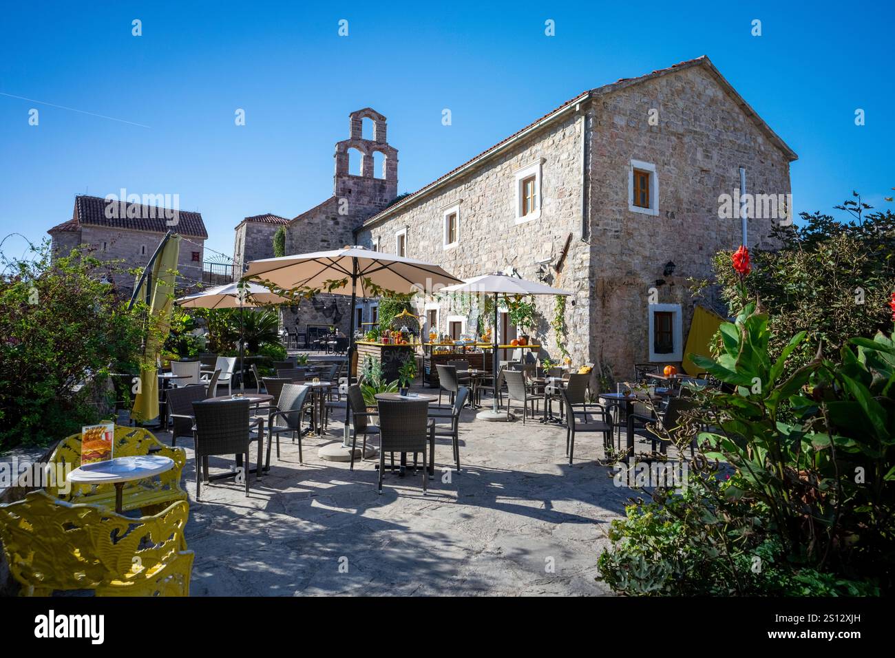 Cafe tables by the monastery in the Medieval town of Budva, Montenegro ...