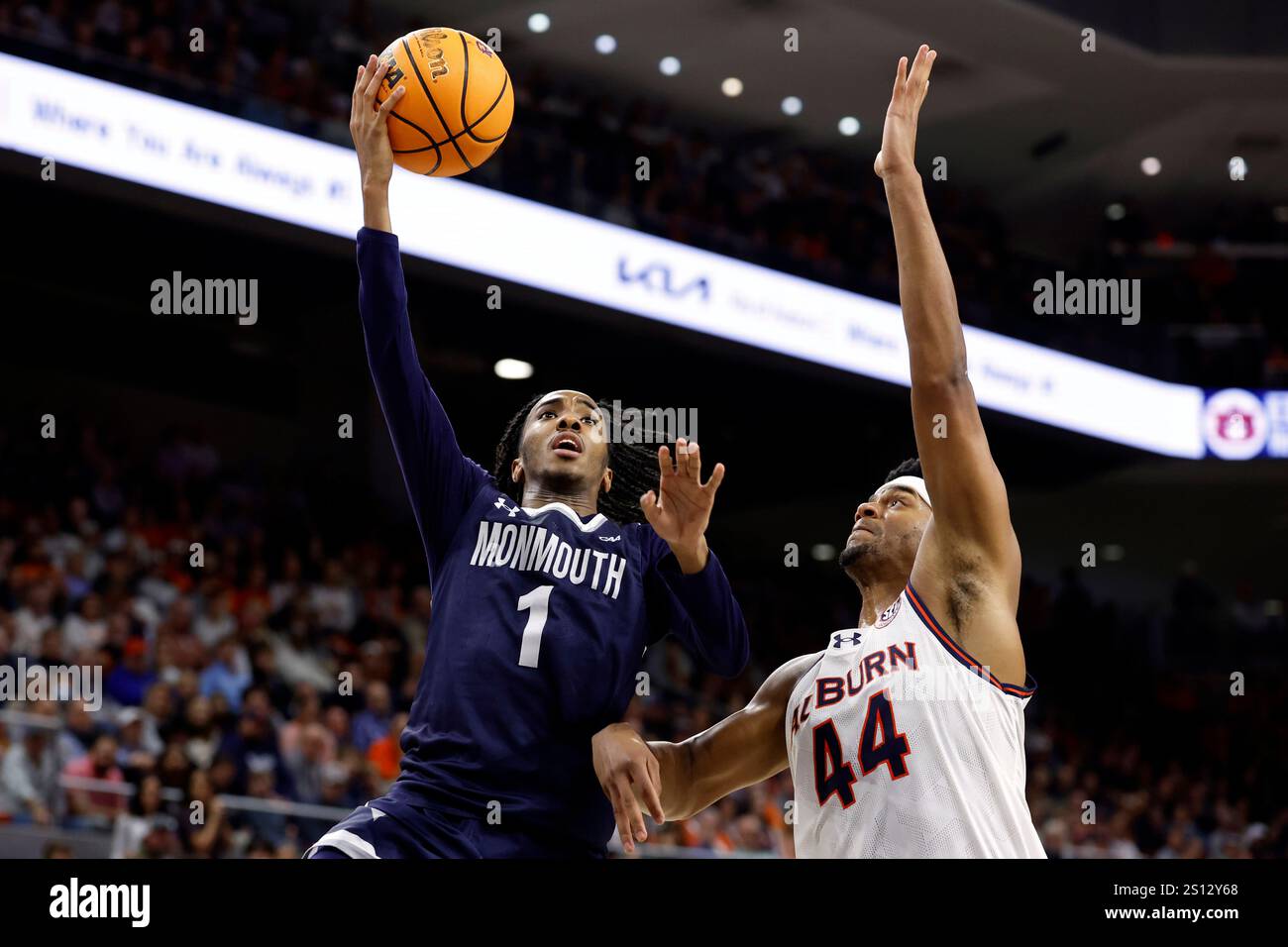 Monmouth guard Abdi Bashir Jr. (1) goes up to shoot over Auburn center ...