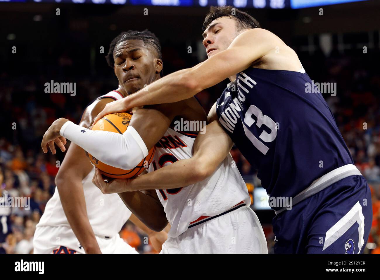 Auburn guard Miles Kelly, front left, and Monmouth guard Jack Collins ...