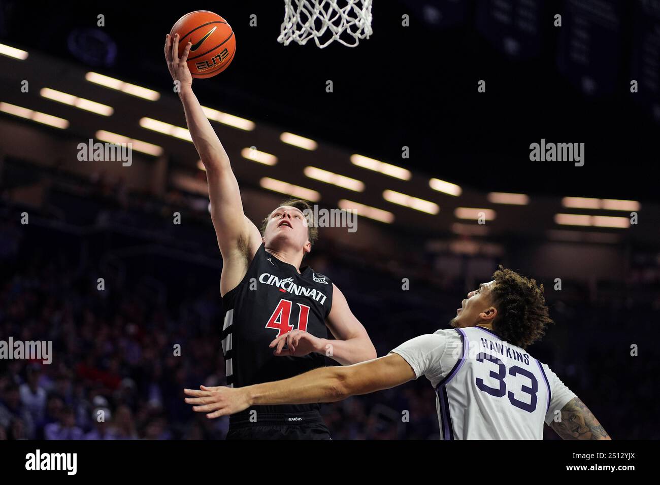 Cincinnati guard Simas Lukosius (41) puts up a shot under pressure from ...