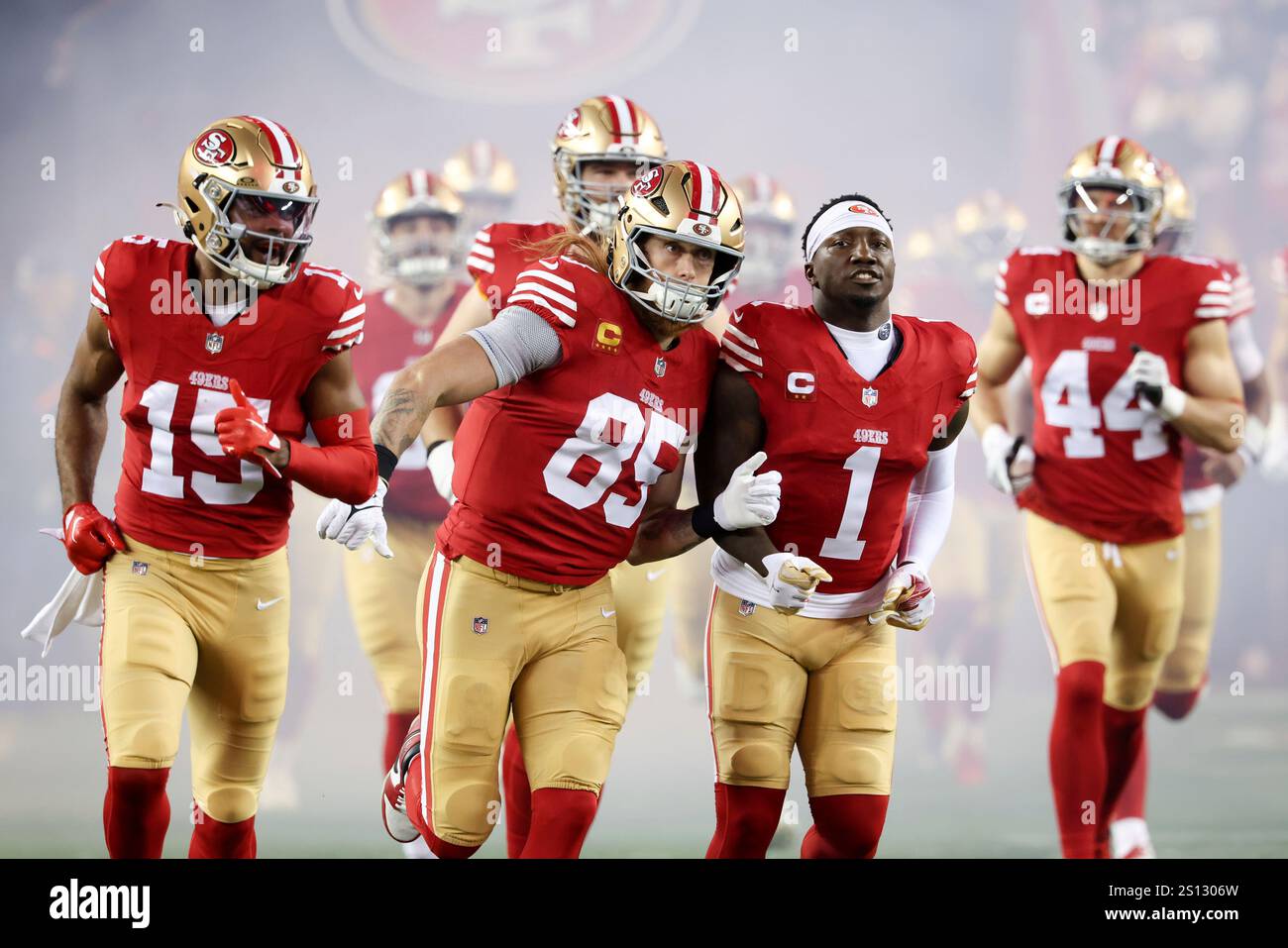 The San Francisco 49ers run onto the field before an NFL football game ...