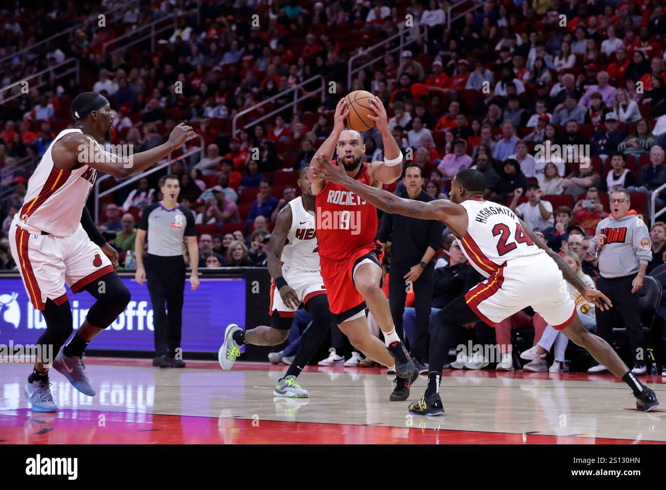Houston Rockets forward Dillon Brooks (9) drives to the basket betwen Miami Heat center Bam ...