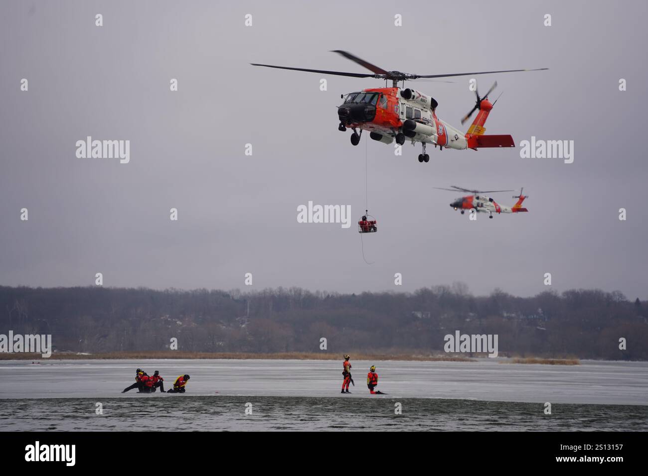 A crew member assigned to Coast Guard Station Manistee is hoisted into ...