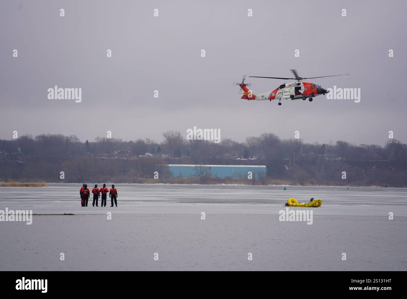 A crew assigned to Coast Guard Station Manistee awaits on the ice Jan ...