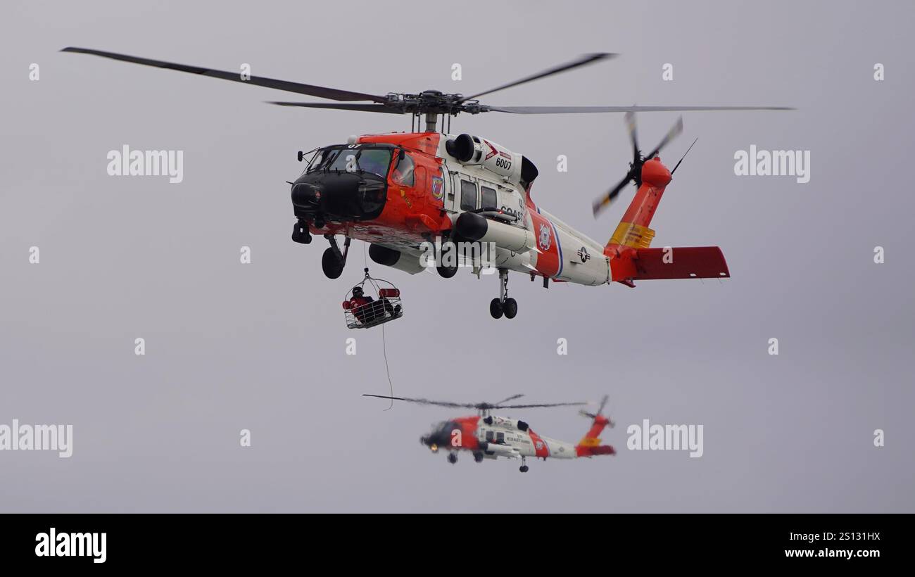 A crew member assigned to Coast Guard Station Manistee is hoisted into ...