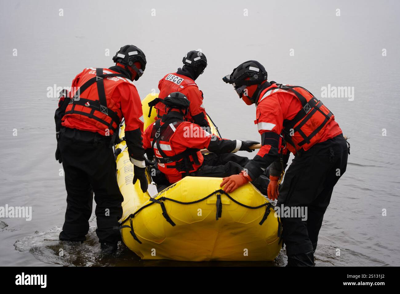 A crew assigned to Coast Guard Station Manistee loads onto a skiff ice ...
