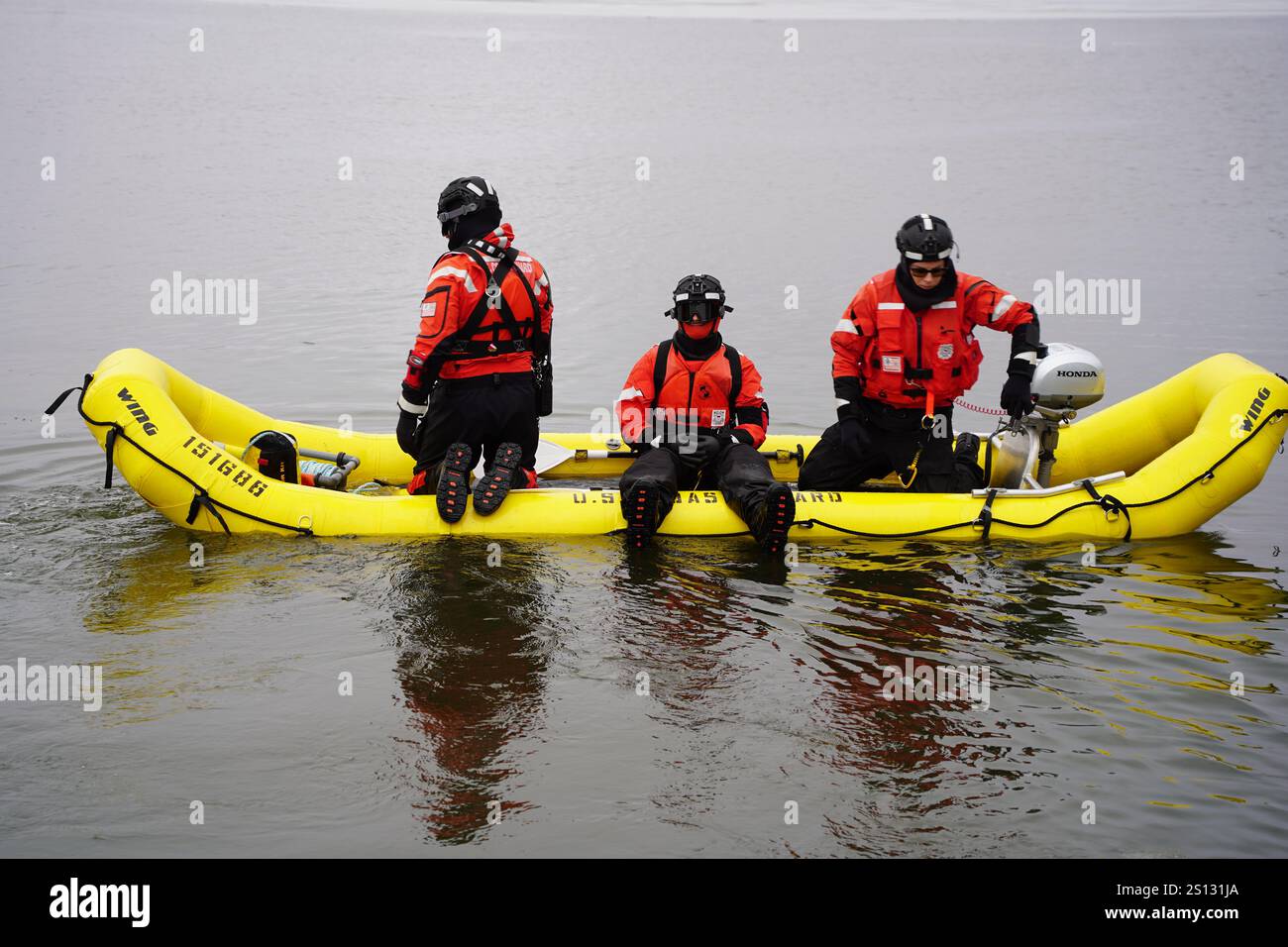 A crew assigned to Coast Guard Station Manistee transits on a skiff ice ...
