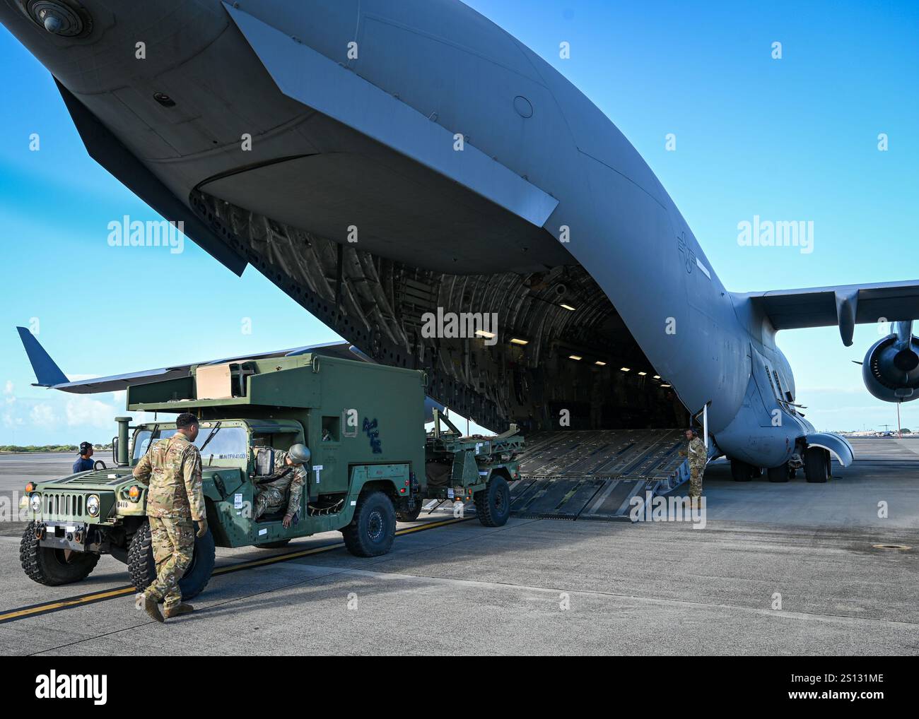 Tech. Sgt. Wilson Starks, 326th Airlift Squadron loadmaster, guides a ...