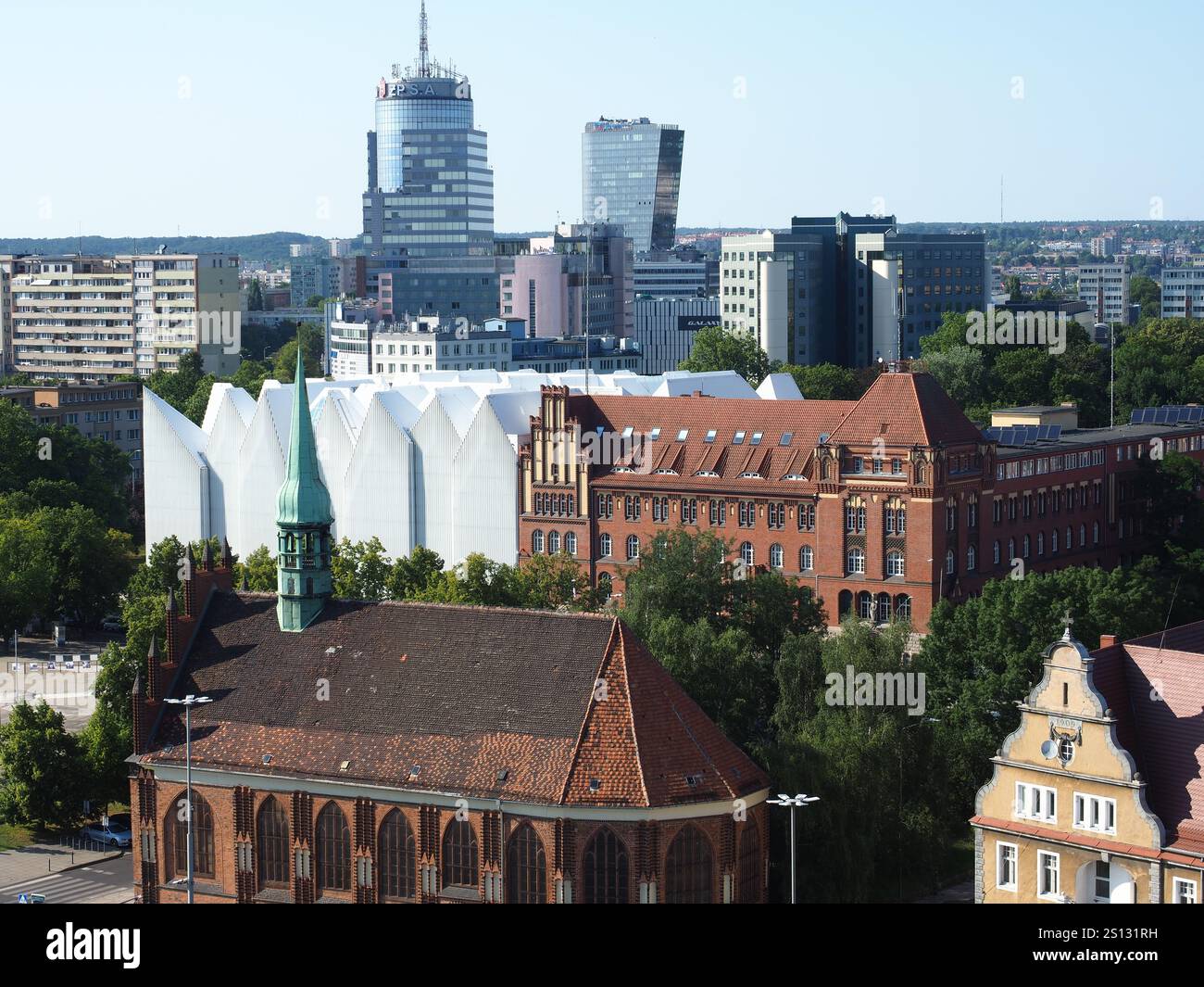 A view of Szczecin city center with two modern buildings, a church and ...