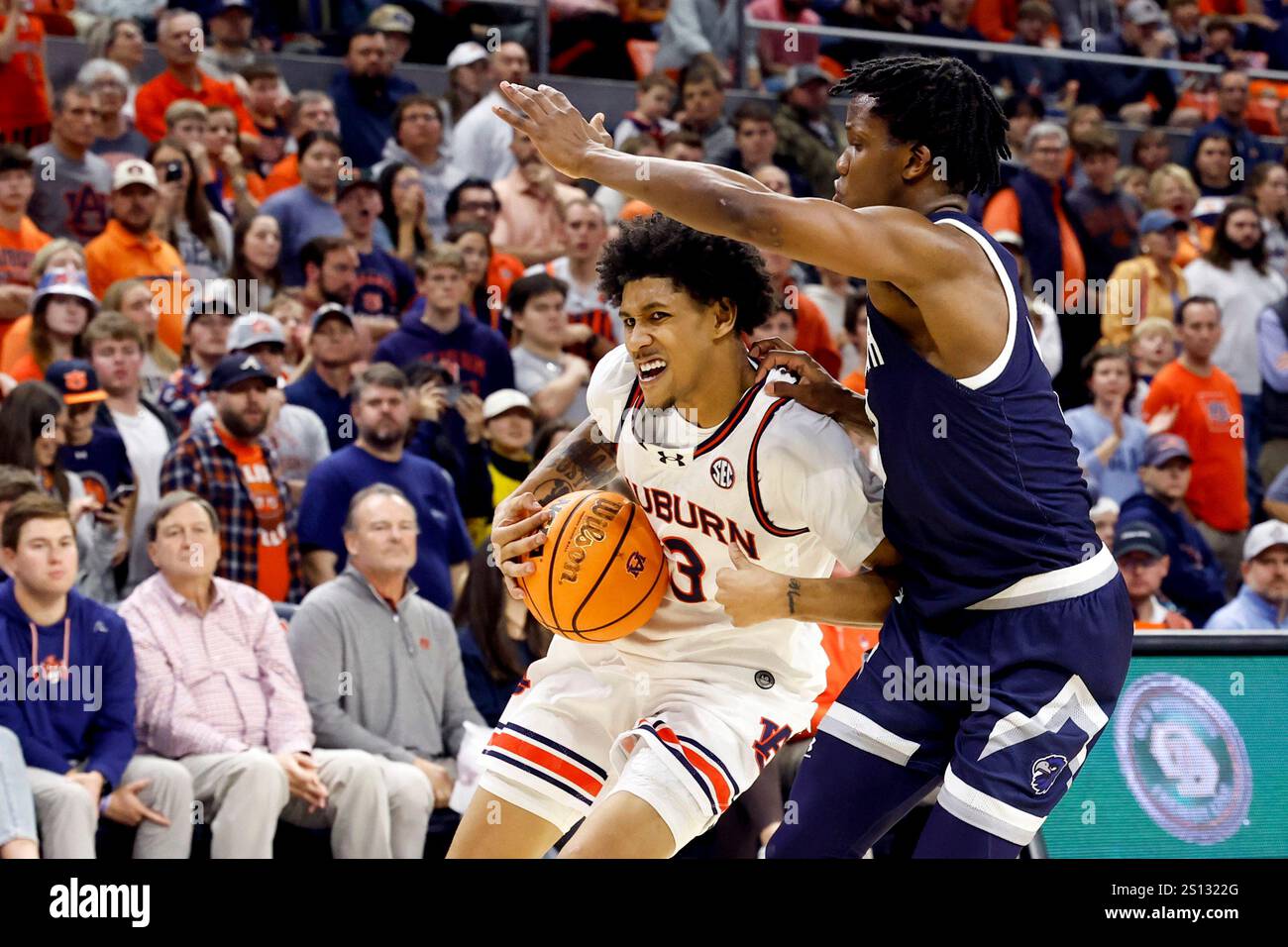 Auburn forward Jahki Howard (3) drives the base line around Monmouth ...