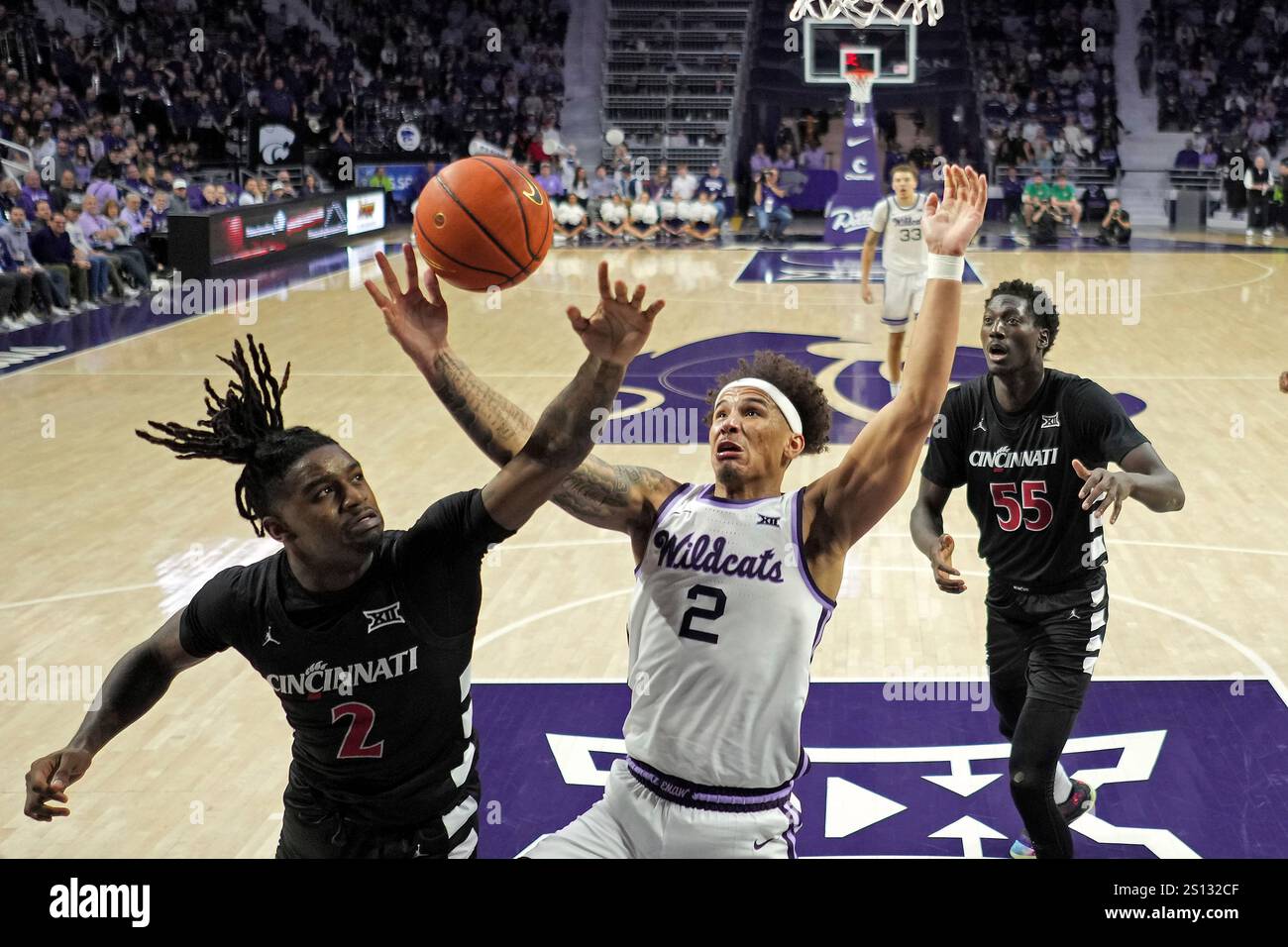 Cincinnati guard Jizzle James, left, and Kansas State guard Max Jones ...