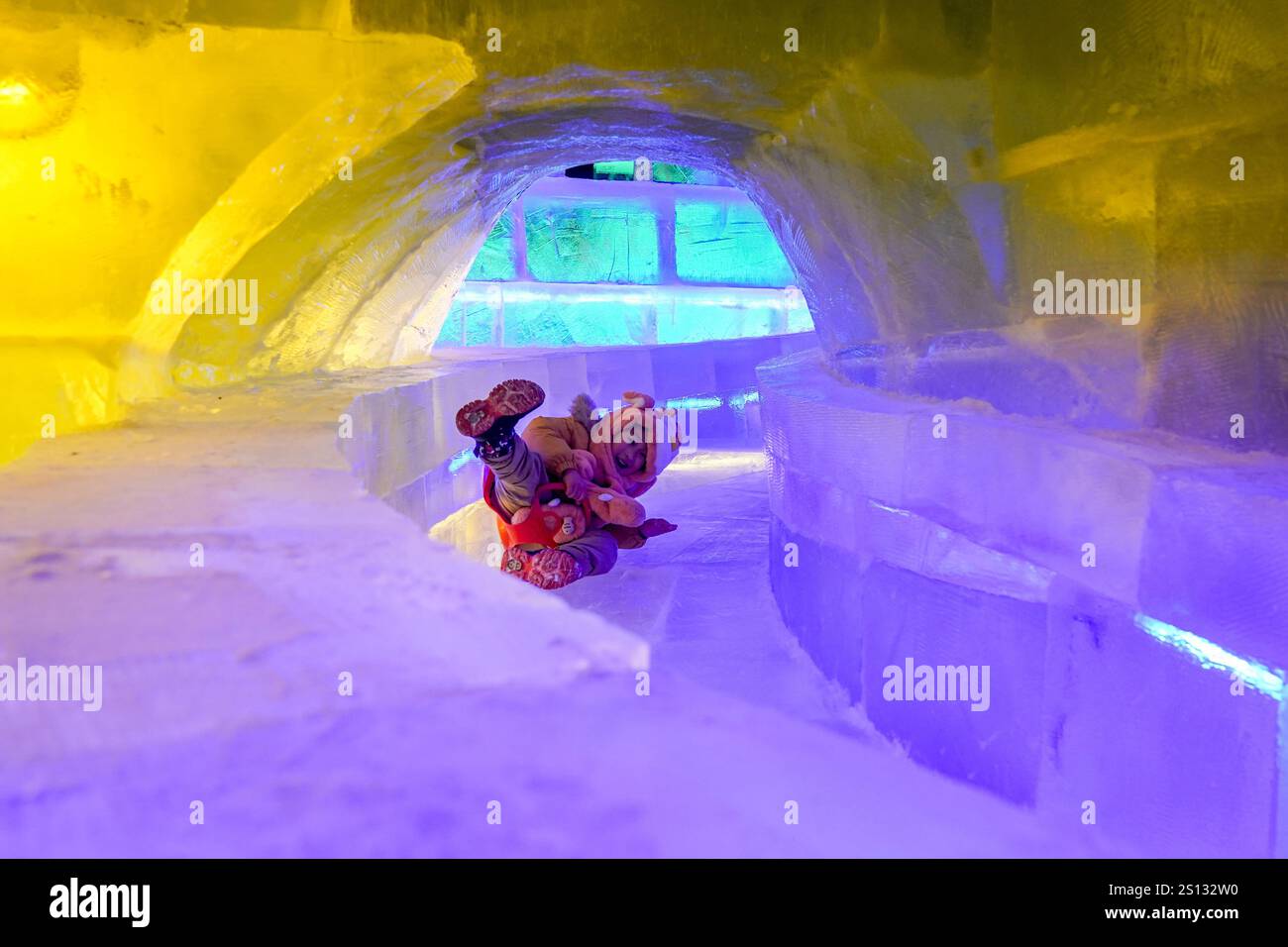 Harbin, China. 30th Dec, 2024. People visit illuminated ice lanterns ...