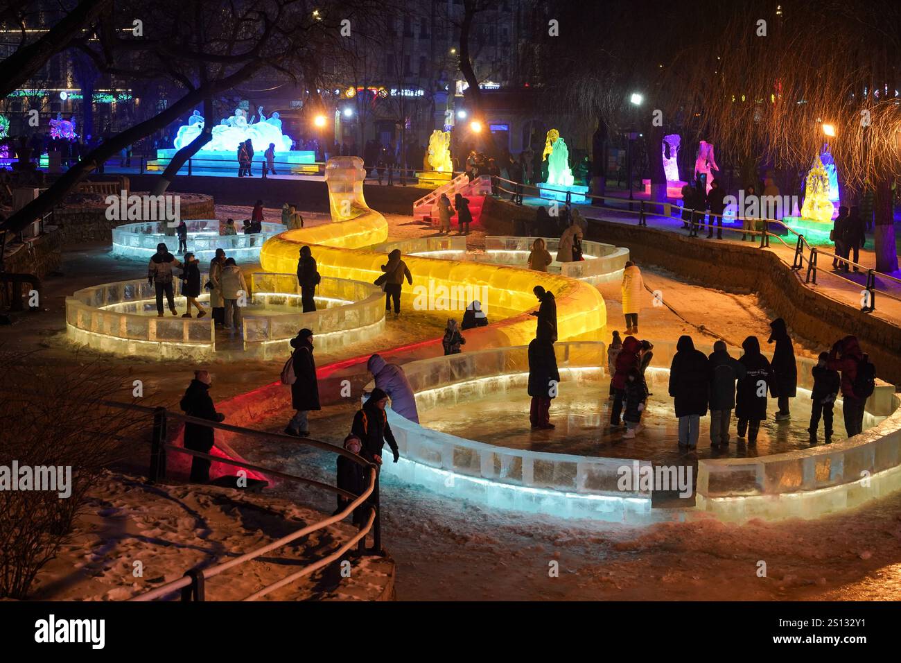 Harbin, China. 30th Dec, 2024. People visit illuminated ice lanterns ...