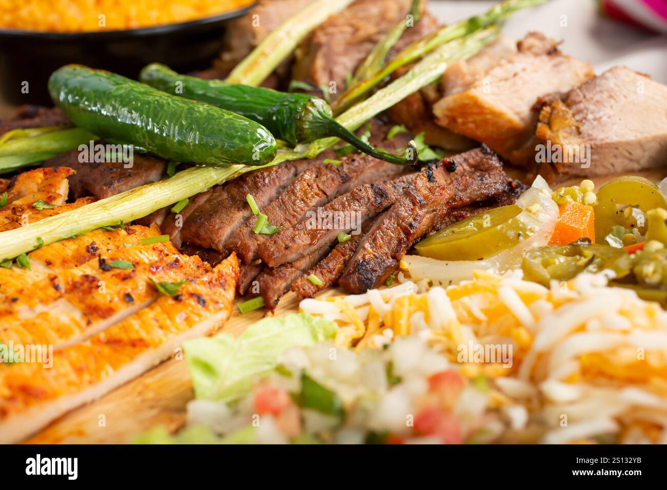 A view of a Mexican food platter, featuring chopped carne asada and ...