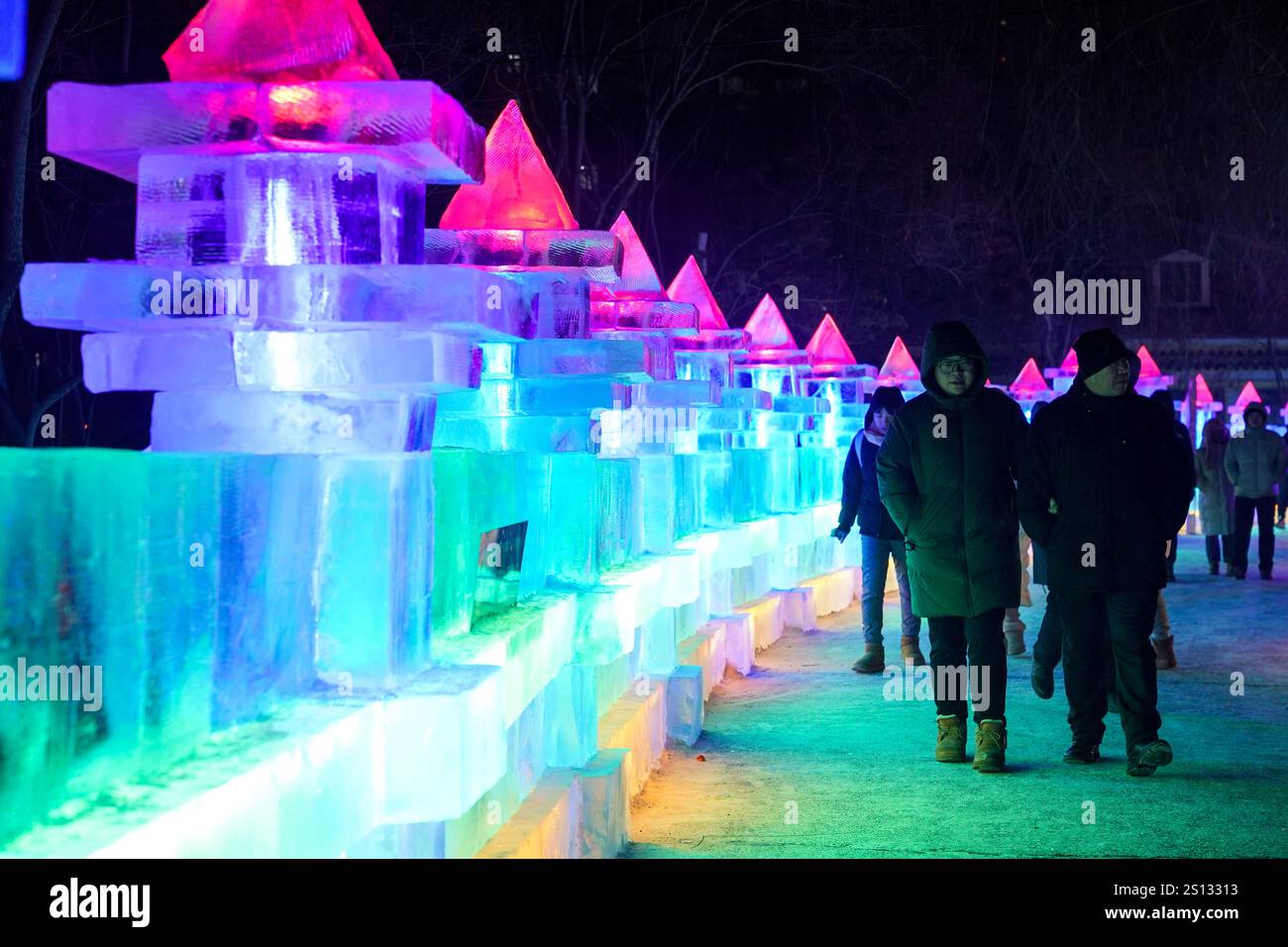 Harbin, China. 30th Dec, 2024. People visit illuminated ice lanterns ...