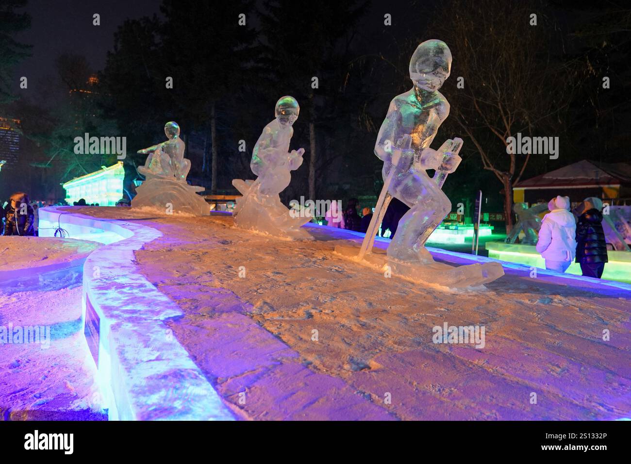 Harbin, China. 30th Dec, 2024. People visit illuminated ice lanterns ...