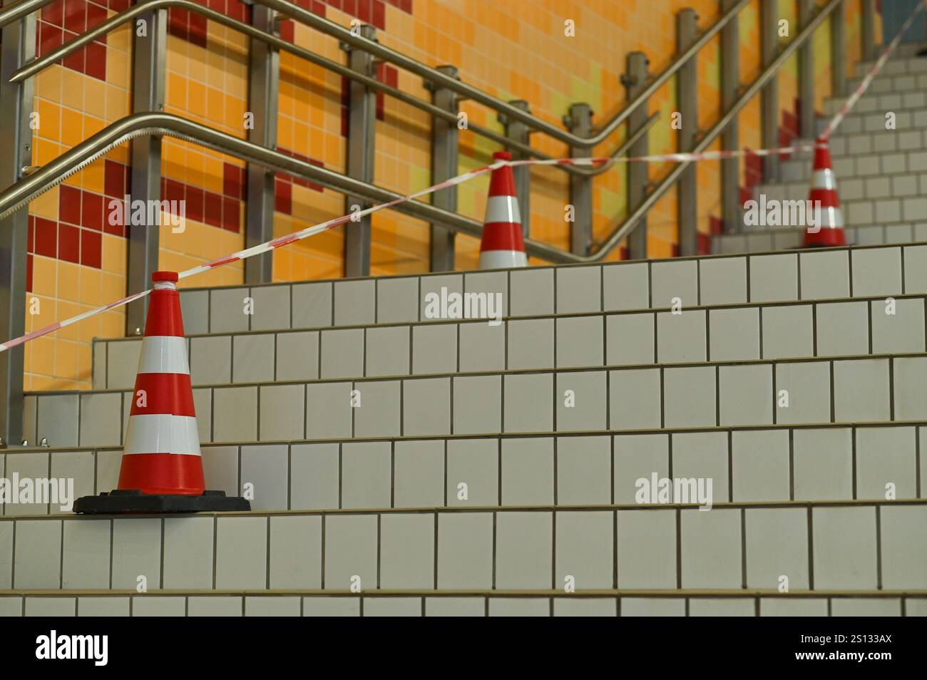 the staircase is lined with ceramic tiles and fenced with cones with ...