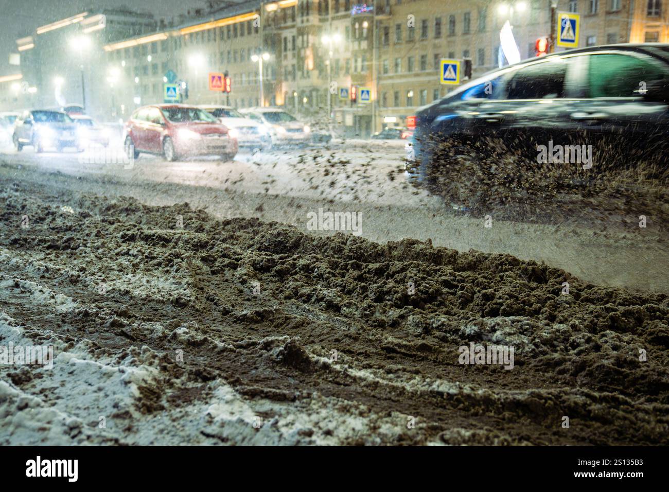Snowstorm and thaw leave road covered in slushy snow dirt grime ...