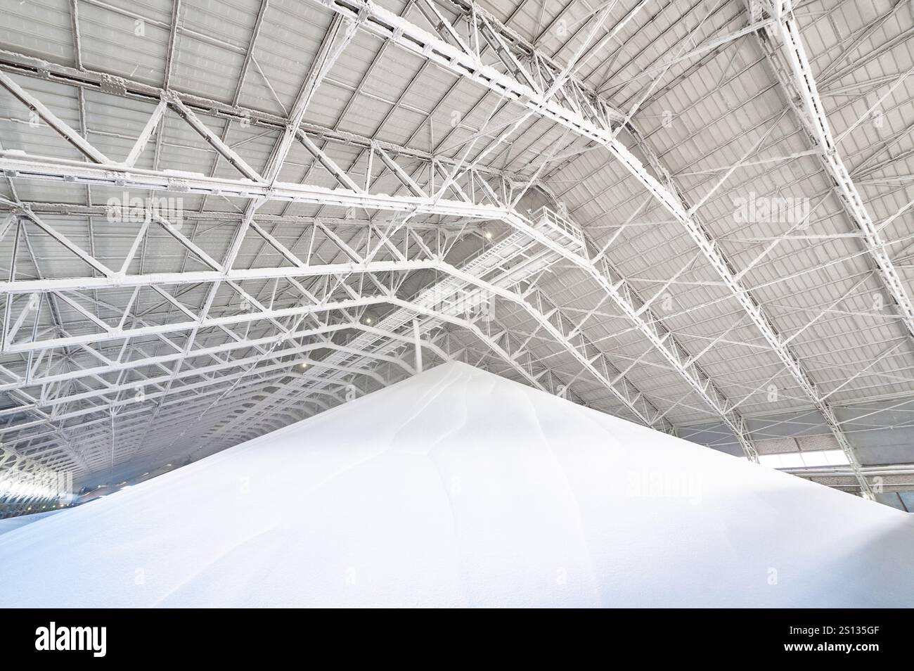Overview of a large chemical warehouse featuring a conveyor system in ...