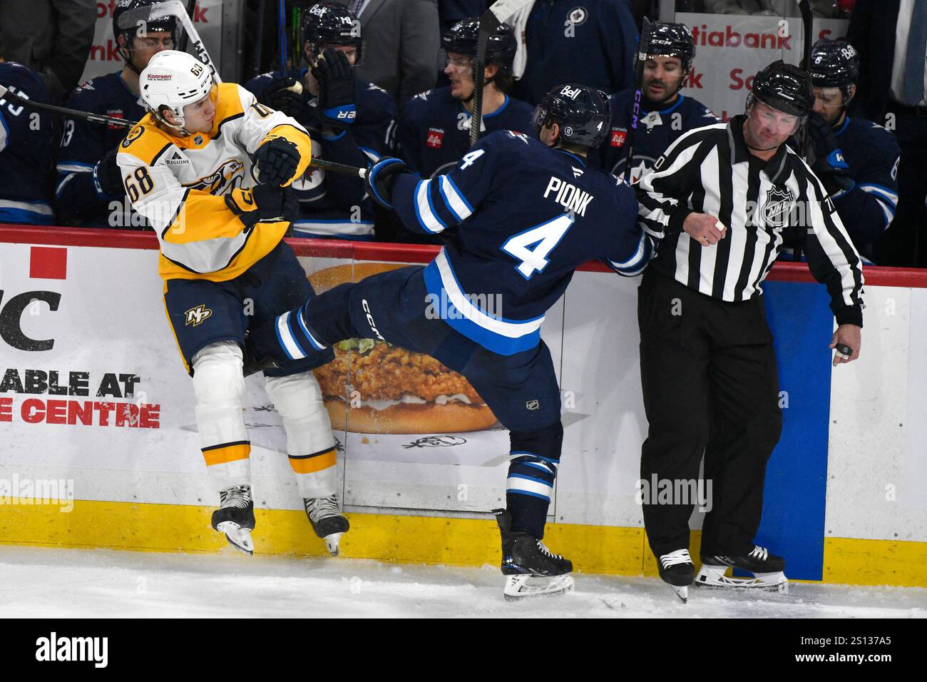 Nashville Predators' Zachary L'Heureux (68) is checked by Winnipeg Jets ...