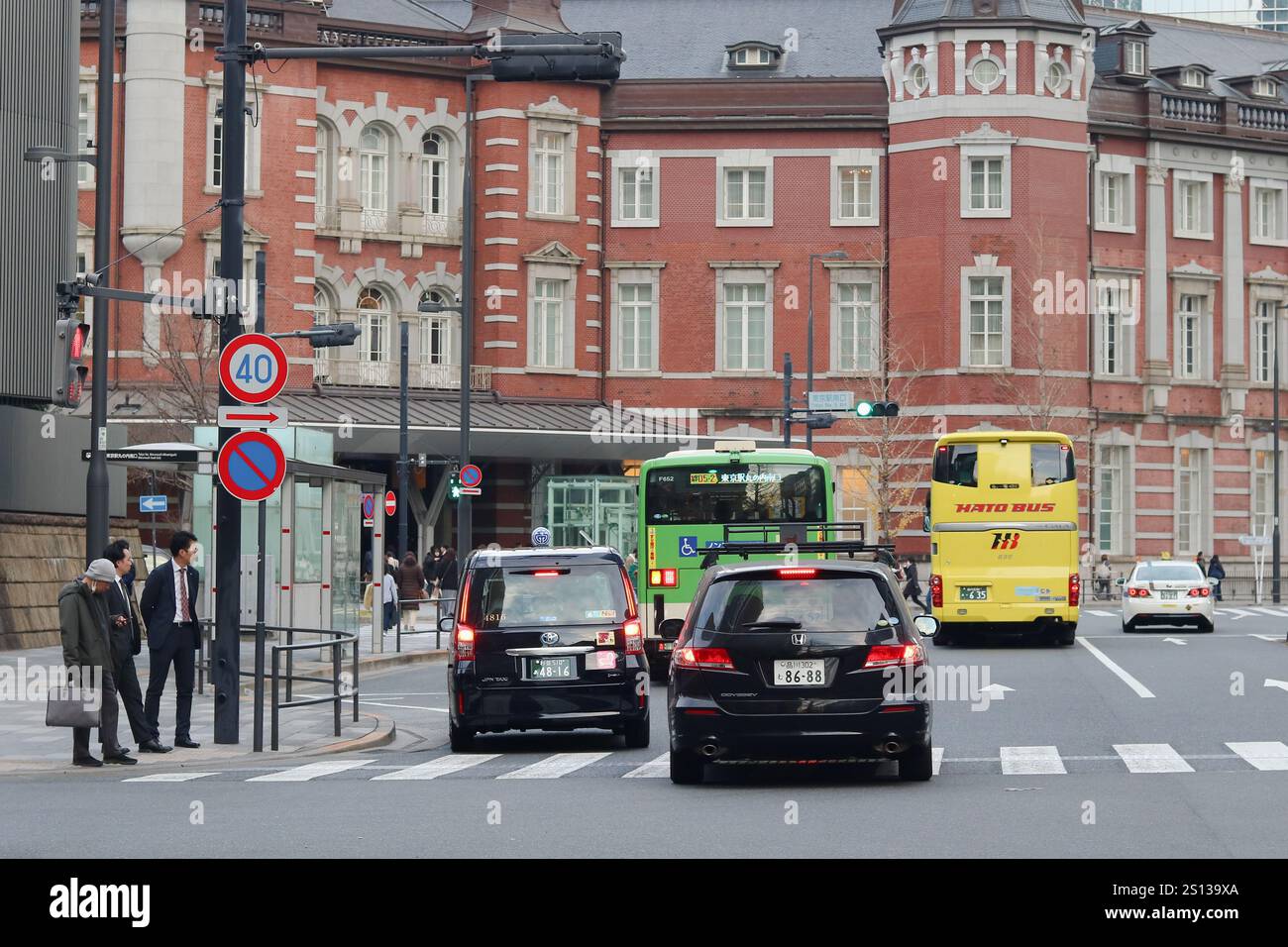 TOKYO, JAPAN - December 26, 2024: Vehicles, including a taxi, a Hato tour bus and a local bus ...