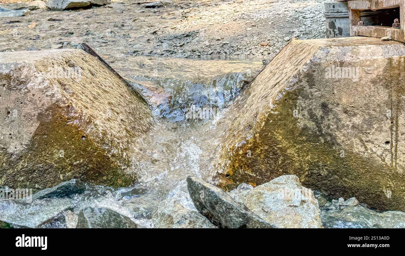 V-notch weir cut into a concrete retaining wall for water restriction ...