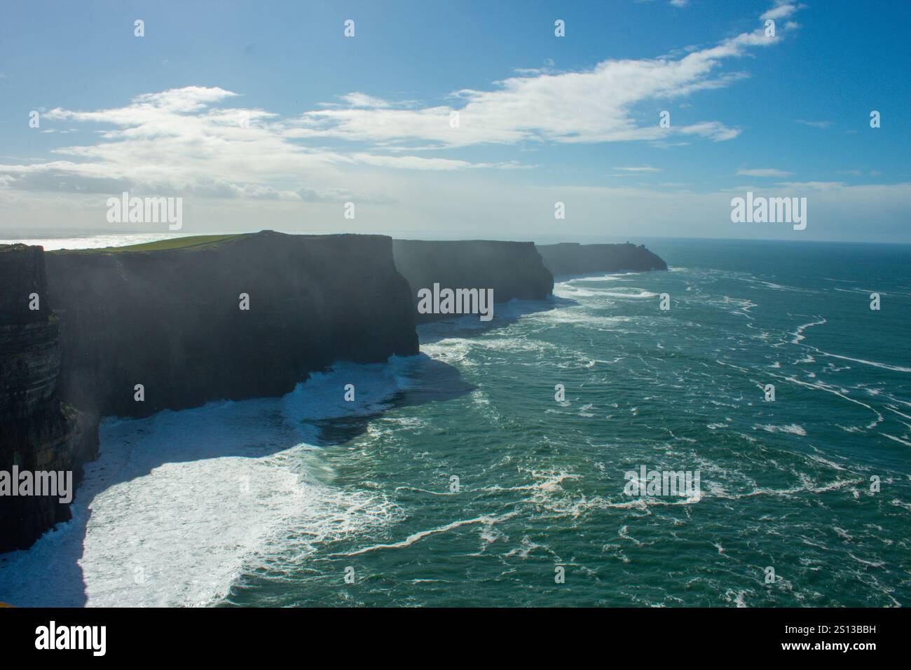 cliffs of moher ireland sunny day looking over the water Stock Photo ...