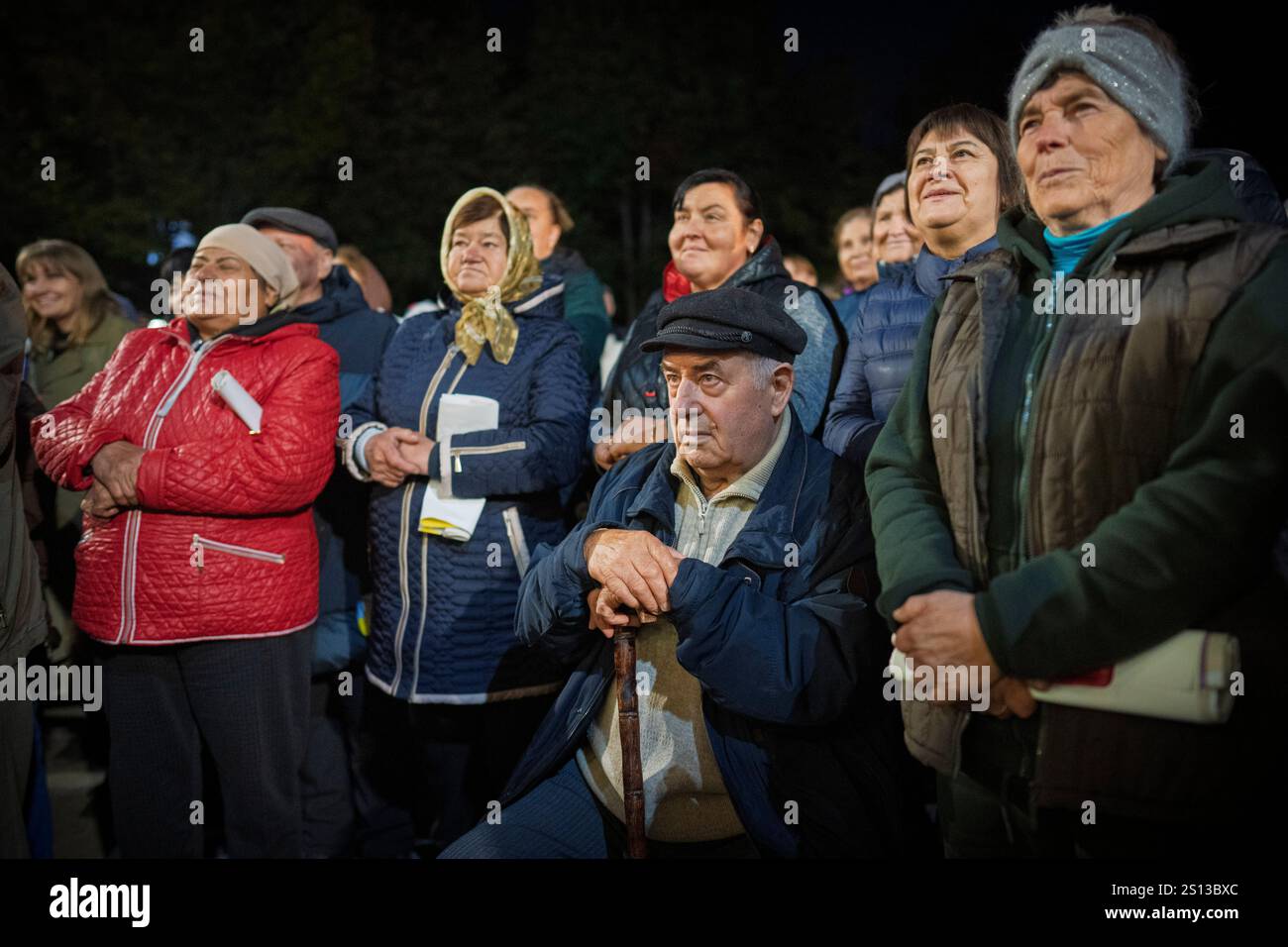 FILE - People listen to Moldova's President Maia Sandu speaking in ...