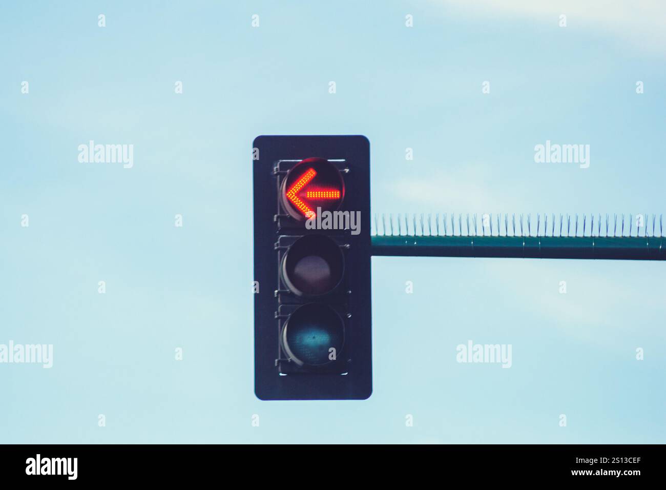 A view of a street light showing a red left turn stop arrow Stock Photo ...