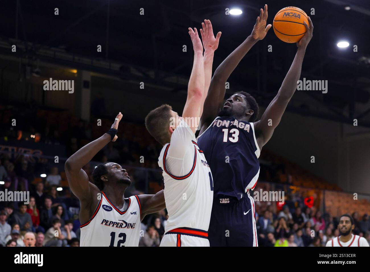 Gonzaga forward Graham Ike, right, shoots against Pepperdine forwards ...