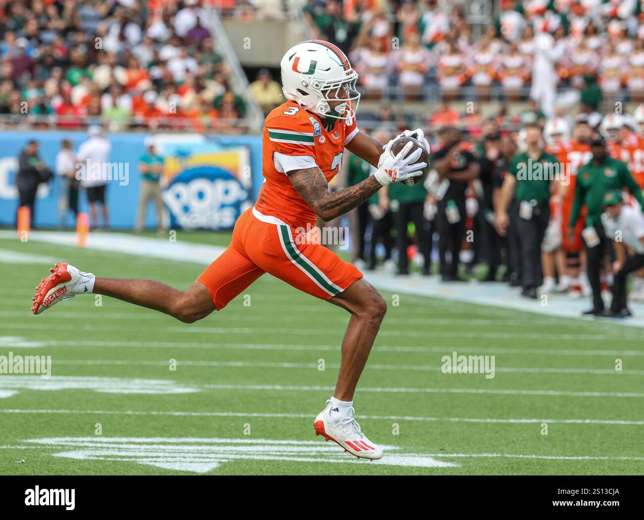 Orlando, FL, USA. 28th Dec, 2024. Miami's Jacolby George (3) snags a ...