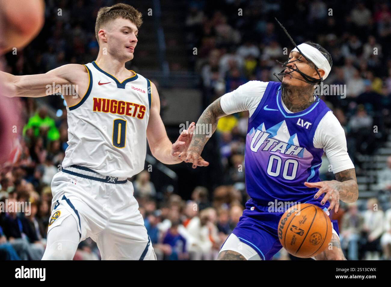 Utah Jazz guard Jordan Clarkson (00) is guarded by Denver Nuggets guard ...