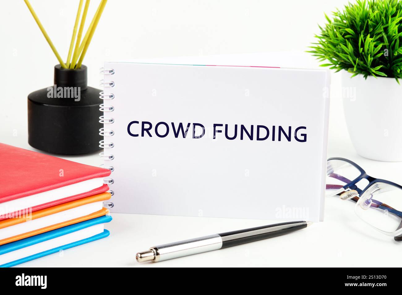 A spiral notebook labeled crowd funding is placed on a tidy desk Stock ...