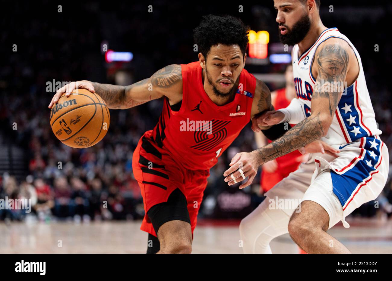 Portland Trail Blazers guard Anfernee Simons, left, dribbles the ball ...