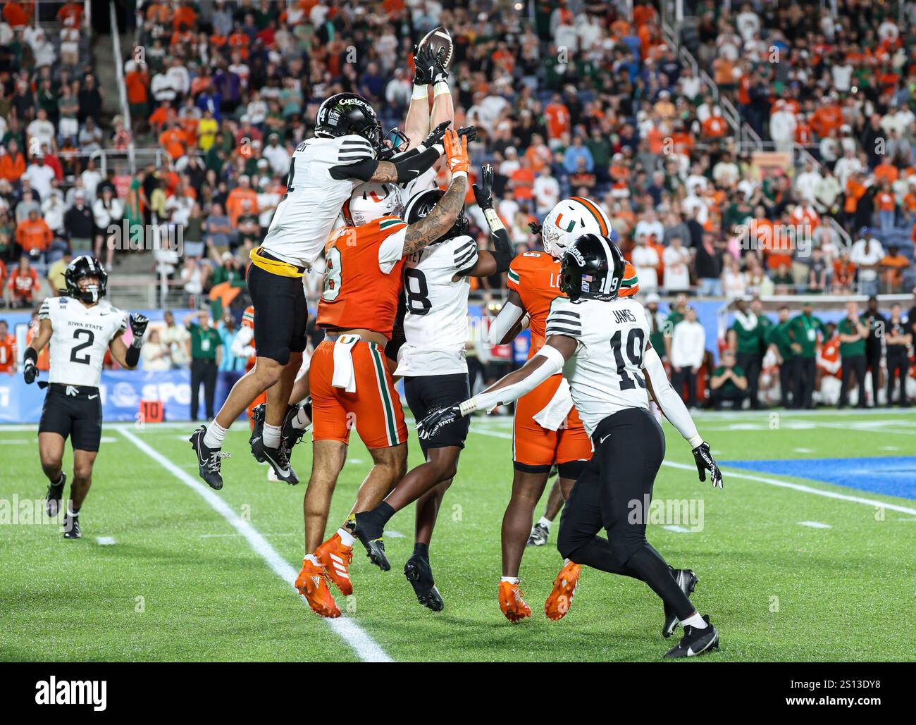 Orlando, FL, USA. 28th Dec, 2024. Miami's final pass of the game is brought down by Iowa State's ...