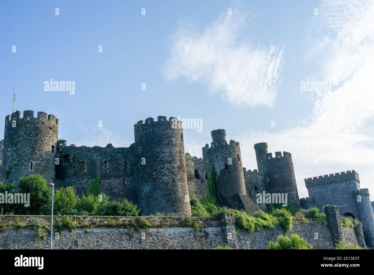 Outside stone fortifications of historic Conwy Castle with it's towers ...