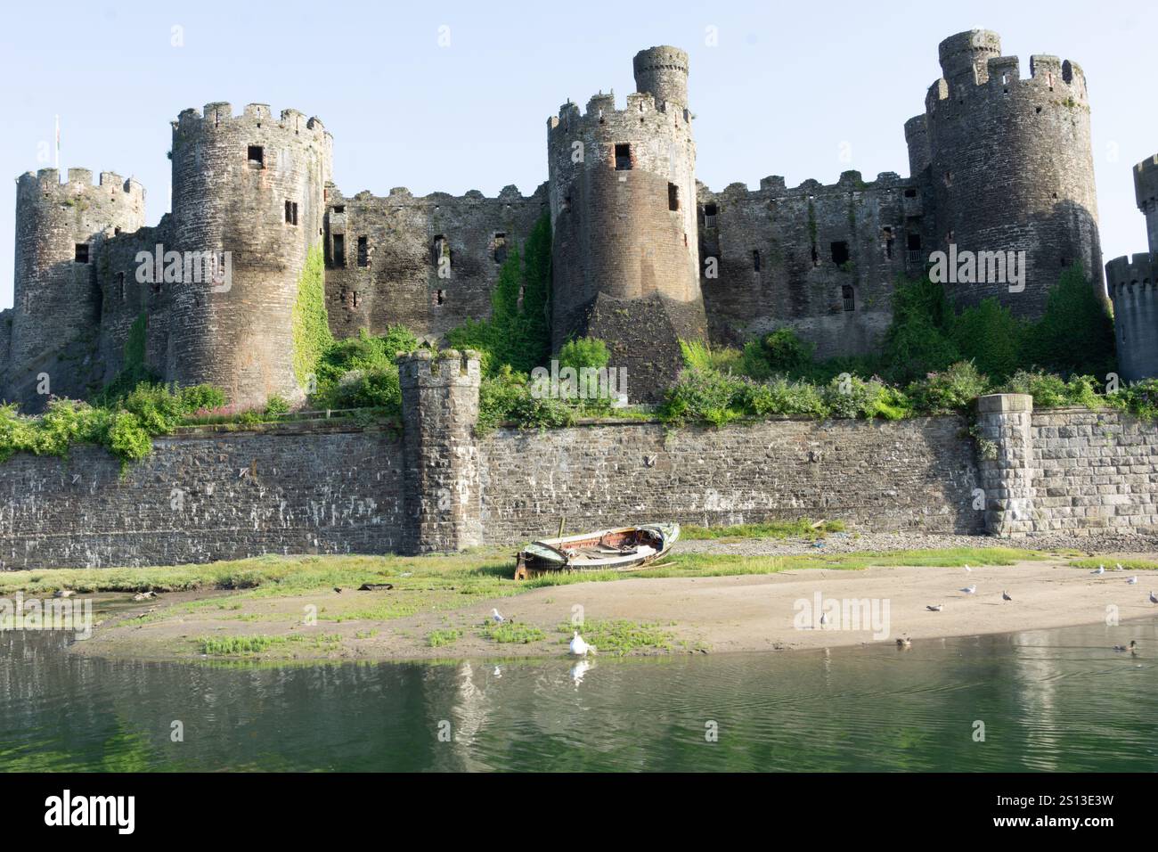 Outside stone fortifications of historic Conwy Castle with it's towers ...